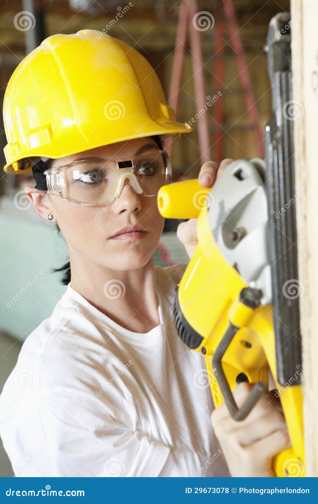 Serious Female Construction Worker Cutting Wood with a Power Saw Stock ...