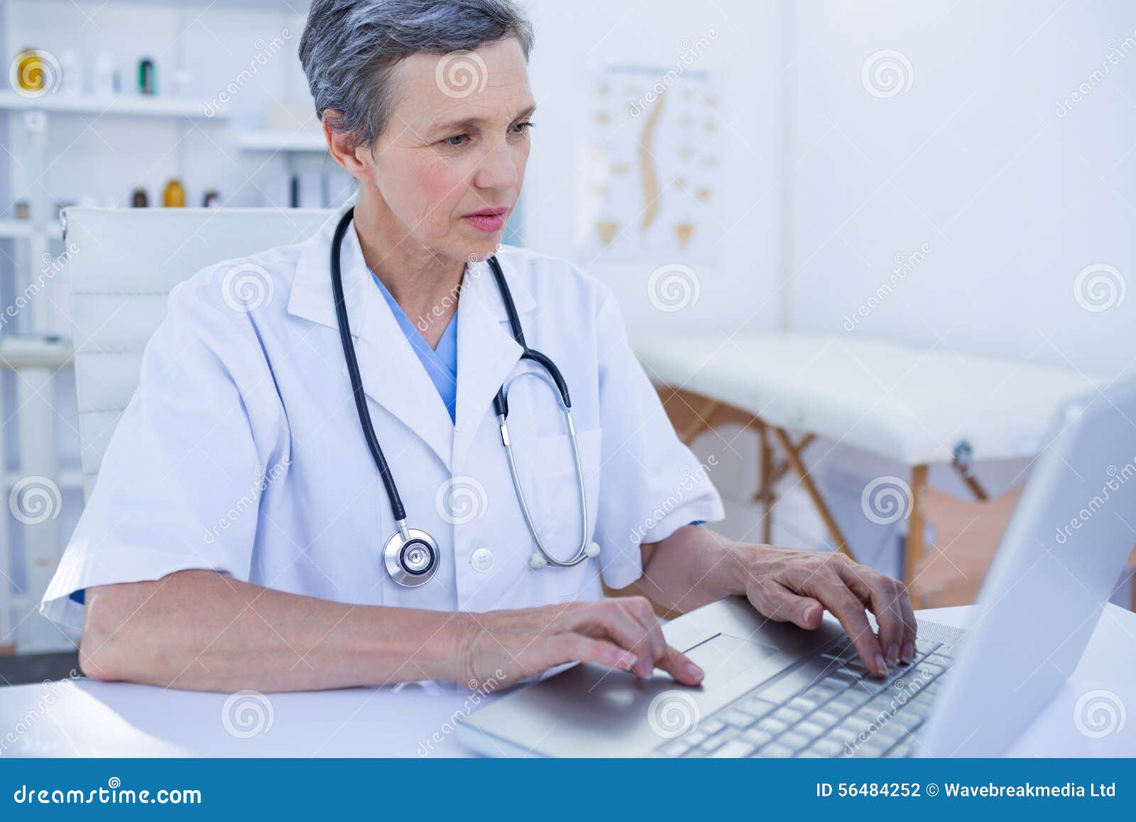 Serious Female Doctor Using Her Laptop Computer Stock Photo - Image of ...