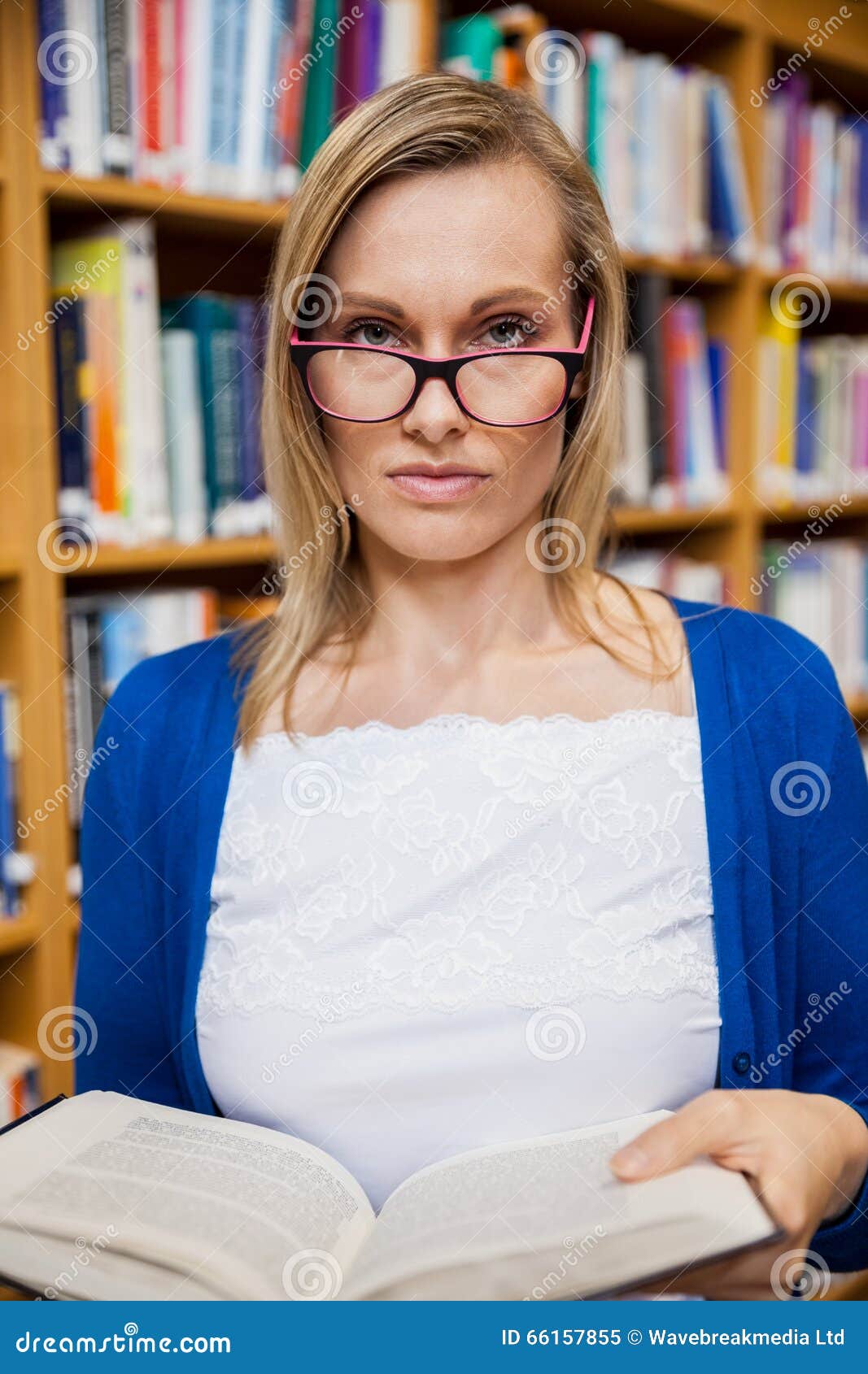 Serious Female Student Reading a Book in the Library Stock Image ...