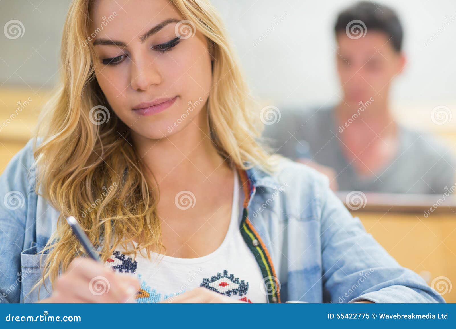 Serious Female Student Writing during Class Stock Image - Image of ...
