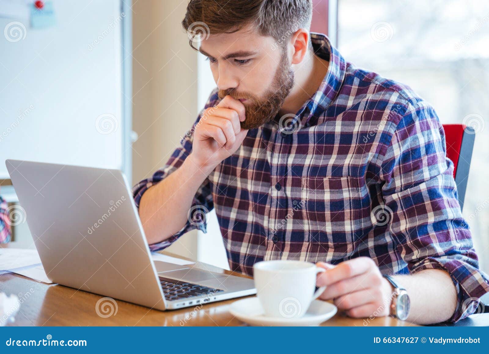 Serious Focused Man Sitting at the Table and Using Laptop Stock Image ...