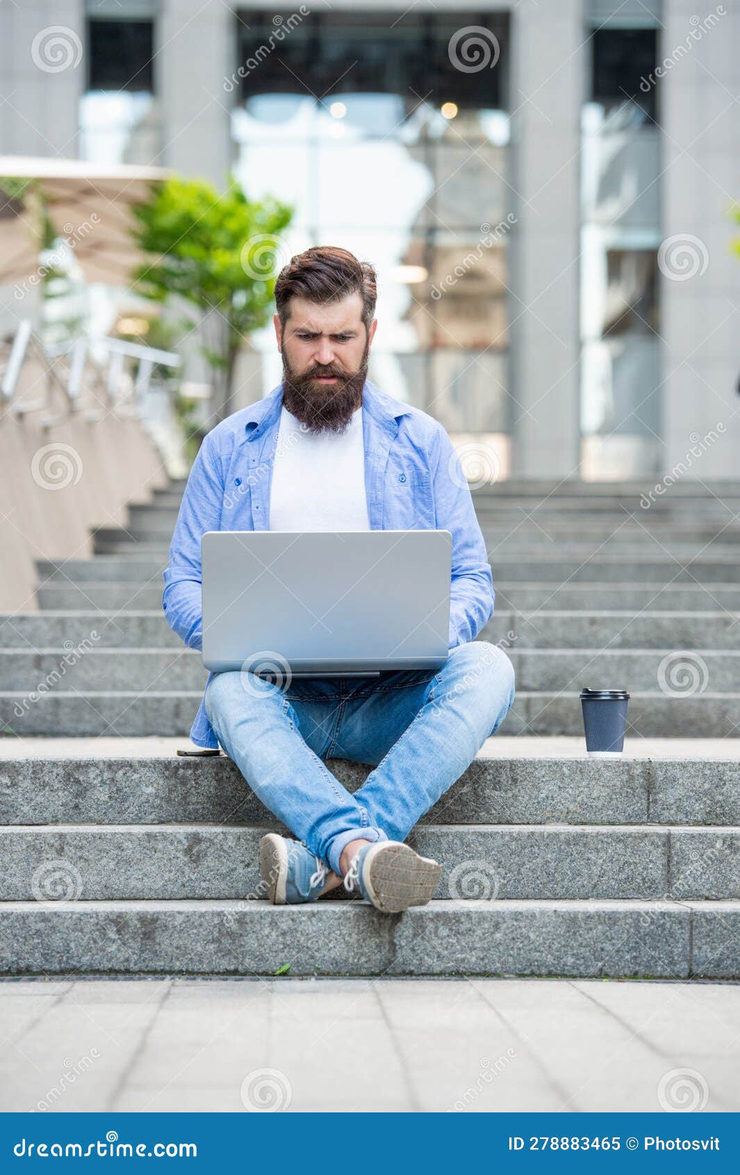 Serious Freelancer Typing on Laptop Sitting on Stairs. Freelancer Man ...