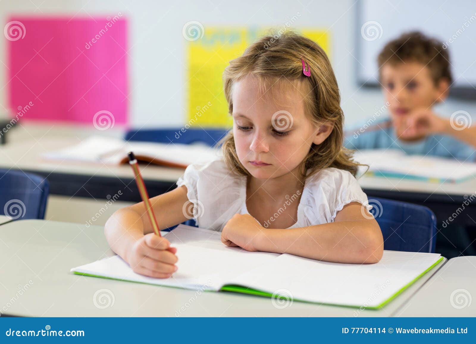 Serious Girl Writing on Book Stock Photo - Image of shoulders ...