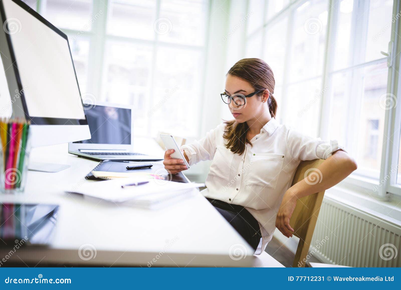 Serious Graphic Designer Using Phone Stock Image - Image of desk, focus ...