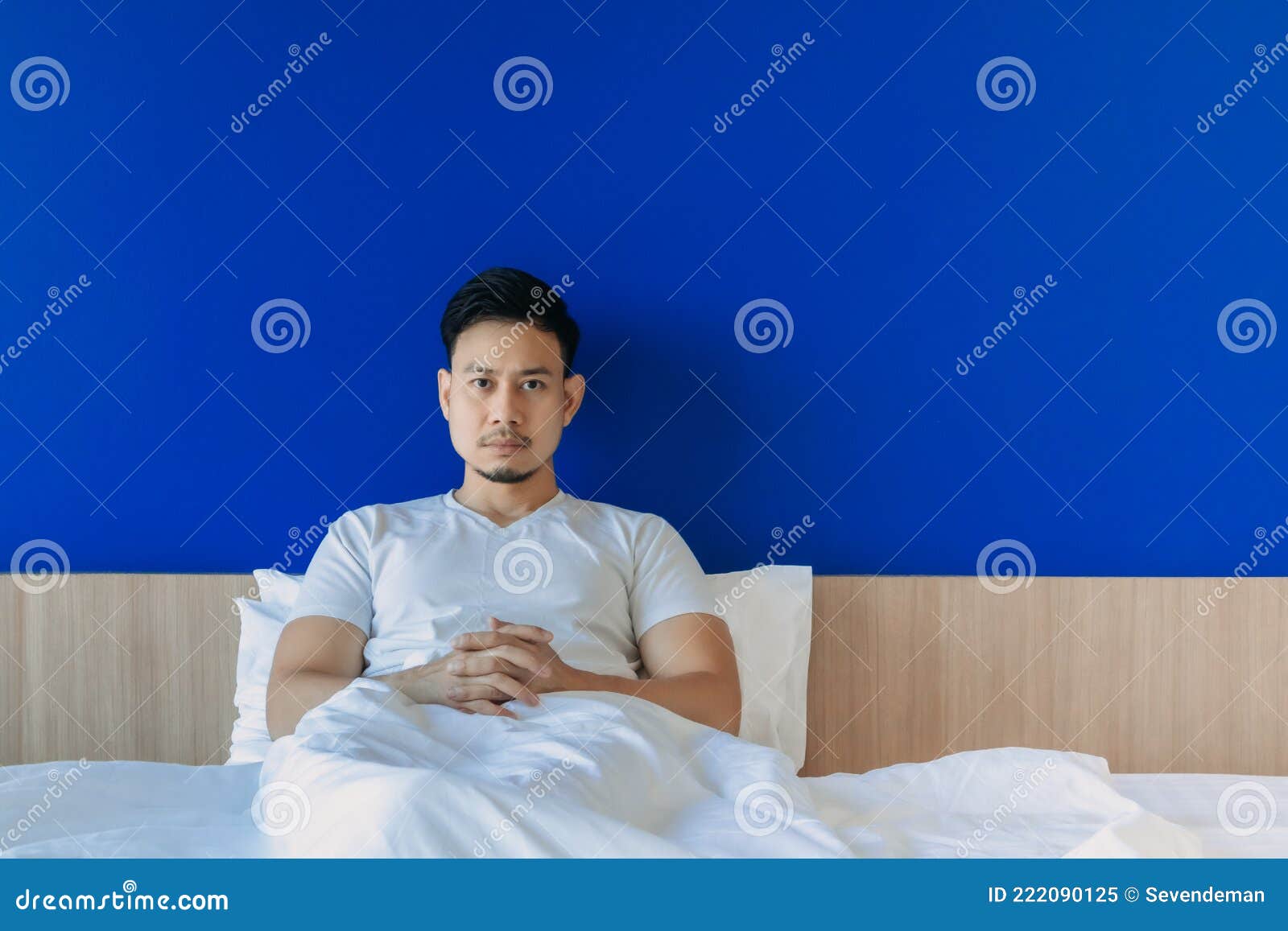 Serious And Grumpy Man Wake Up On The Bed On Blue Space Background ...