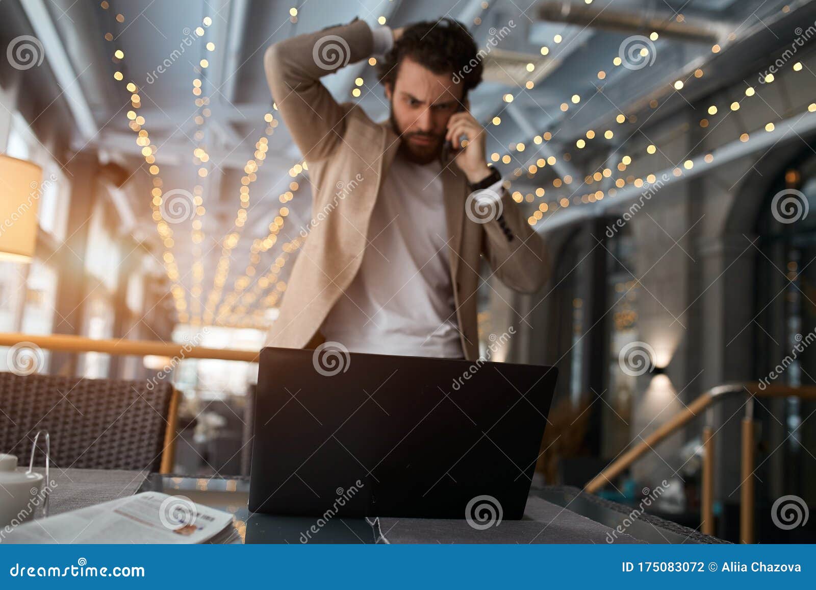 Serious Guy Having Problems with Computer, Scratching His Head Stock ...