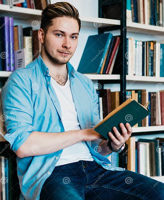 Serious Guy Reading Book in Library Stock Image - Image of creative ...