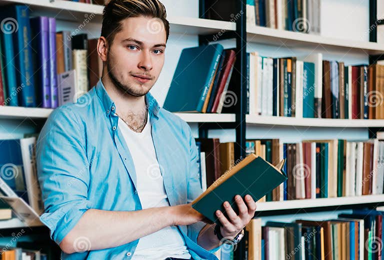 Serious Guy Reading Book in Library Stock Image - Image of camera ...