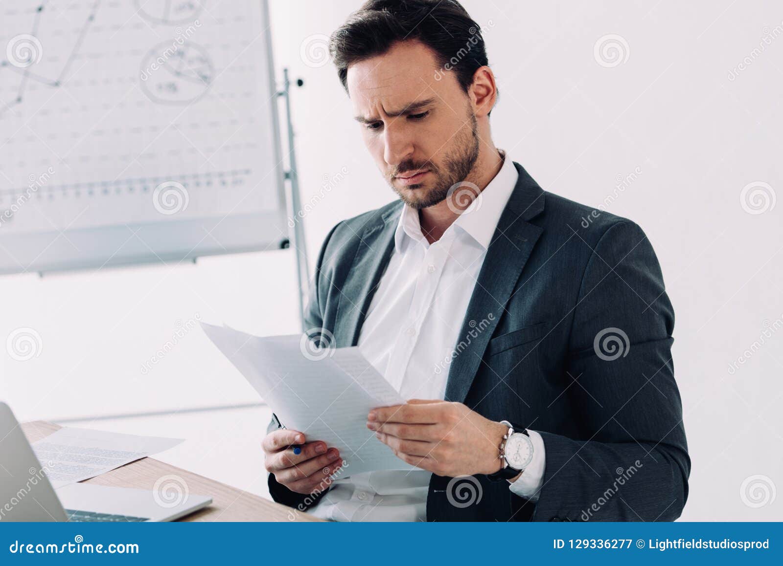 Serious Handsome Businessman Reading Documents Stock Image - Image of ...