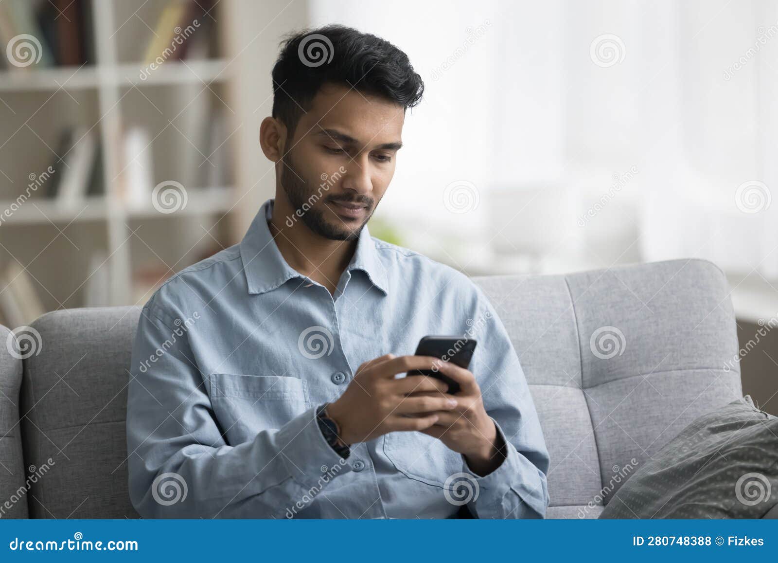 Serious Handsome Young Indian Man Using Gadget for Internet ...