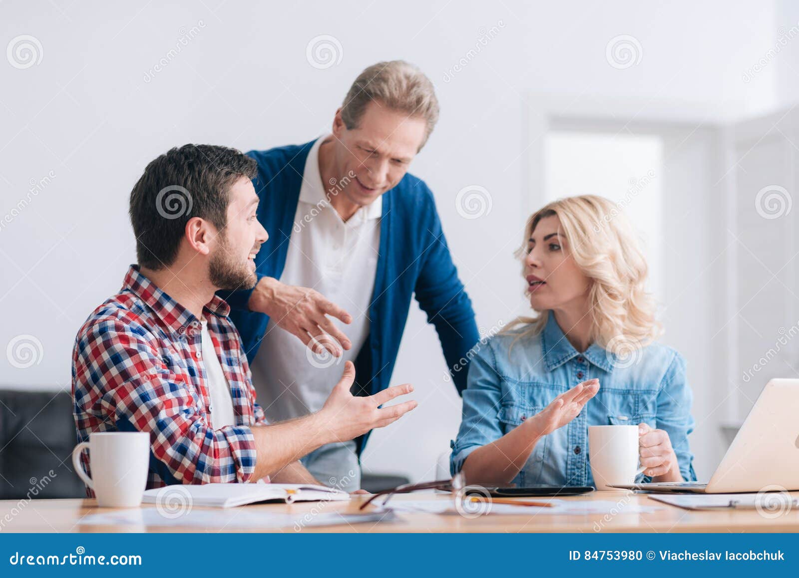 Serious Hard Working Colleagues Discussing Something Stock Photo ...