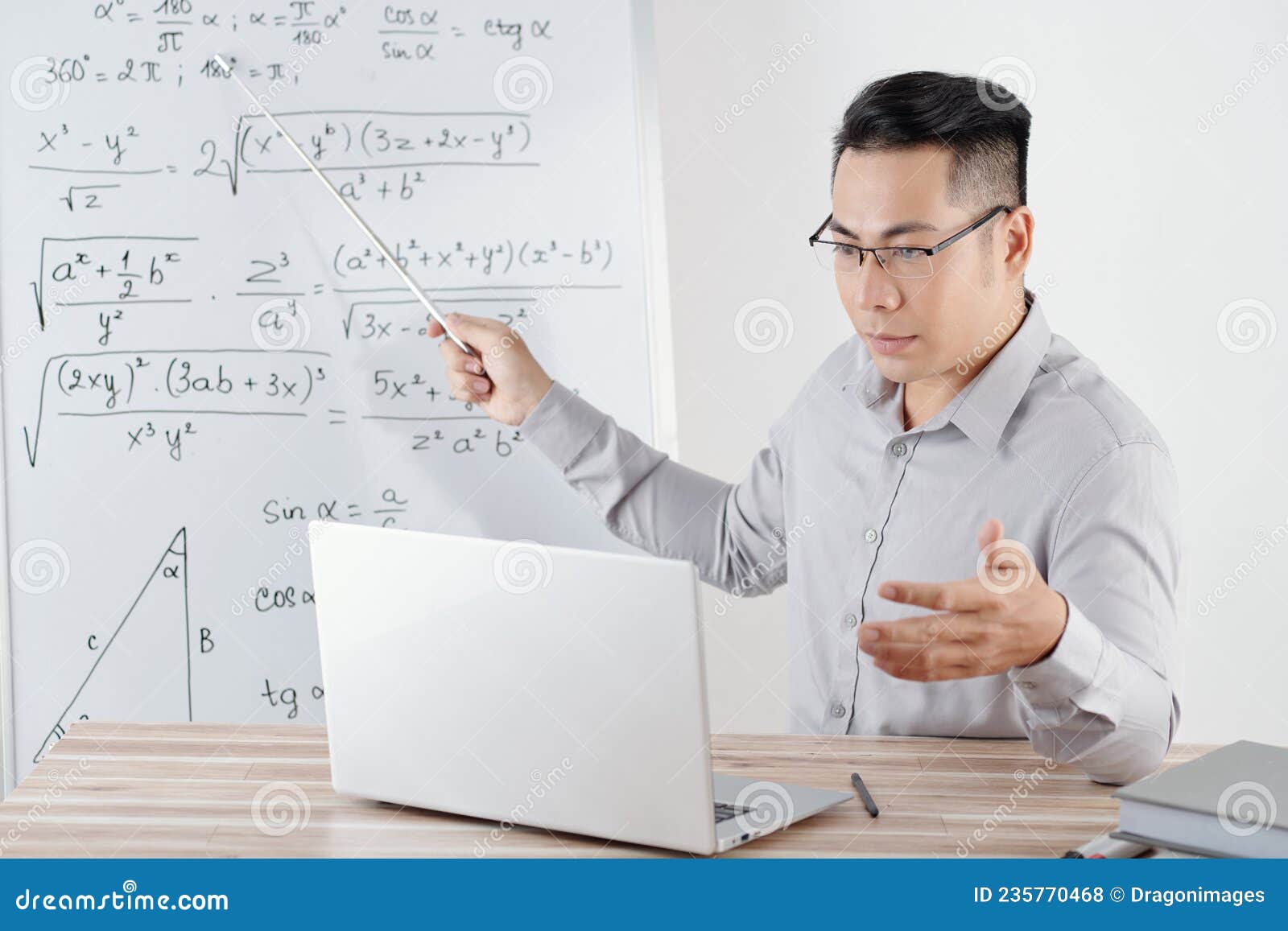 Math Teacher Pointing at Whiteboard Stock Photo - Image of eyeglasses ...