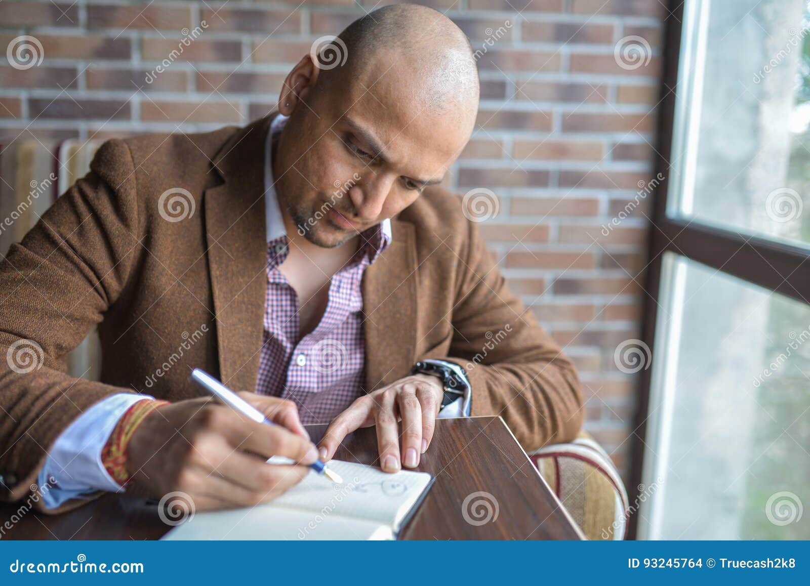 Serious Indian Man Making Some Notes in His Notebook, Business Plan or ...