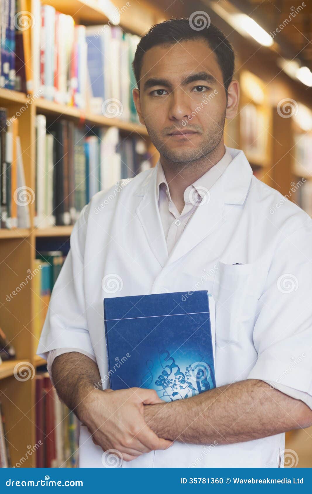Serious Intellectual Man Posing in Library with a Book Stock Photo ...