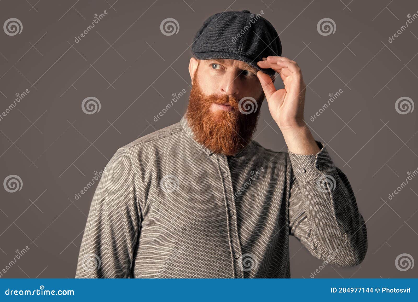 Serious Irish Guy Adjusting Cap. Portrait of Bearded Guy Stock Photo ...