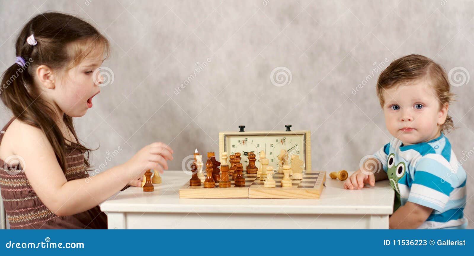 Serious kids playing chess stock image. Image of infant - 11536223