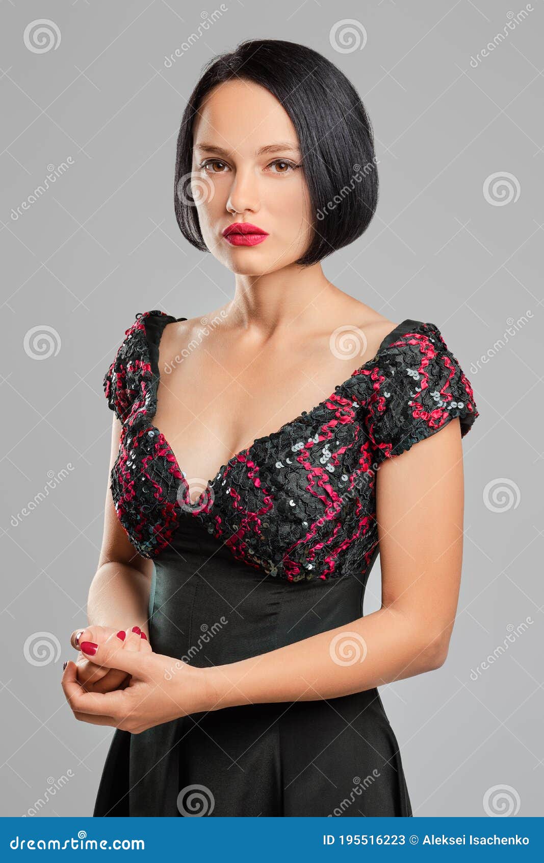 Serious Lady with Short Dark Hair and Red Lips Posing in Studio Stock ...