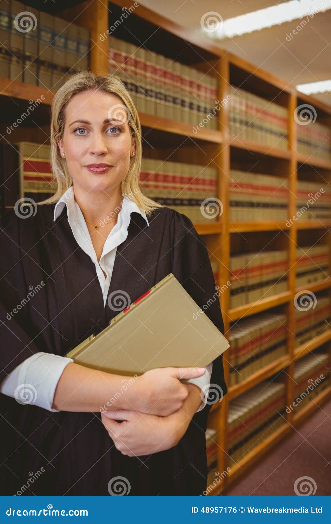Serious Lawyer Holding a File while Standing Stock Photo - Image of ...