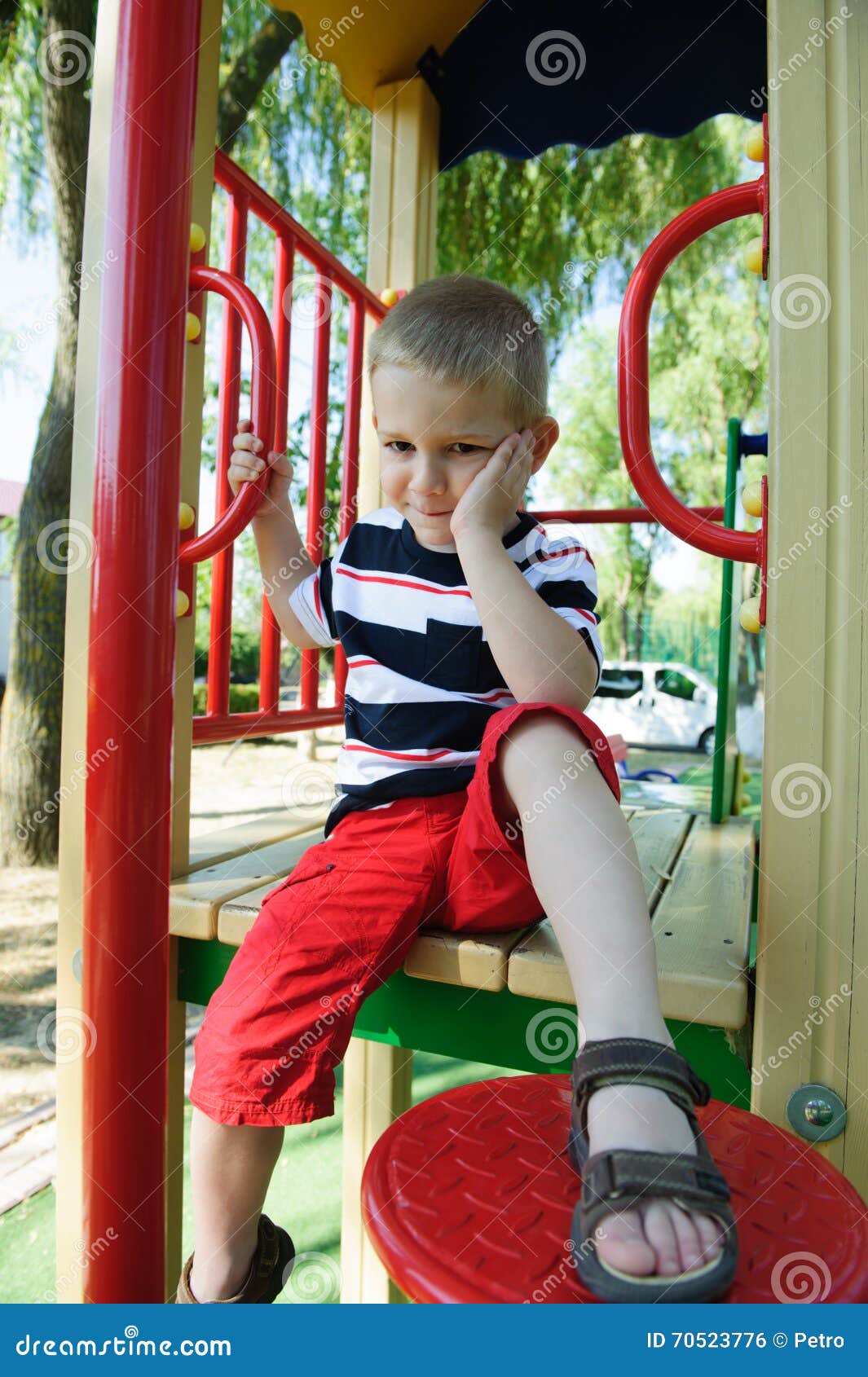 Serious Little Boy Sitting at Playground Stock Photo - Image of person ...