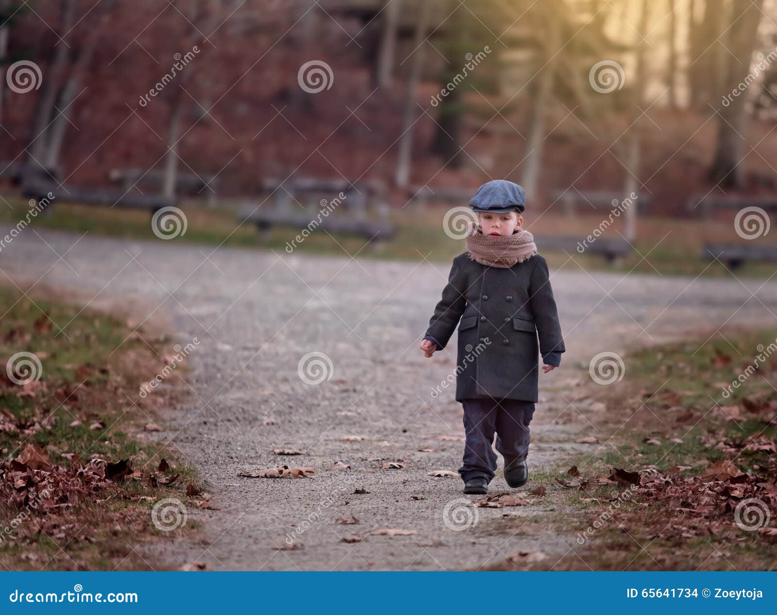 Serious Little Boy Wearing a Hat Walking on a Path in a Park on a Chilly Day Stock Photo - Image ...