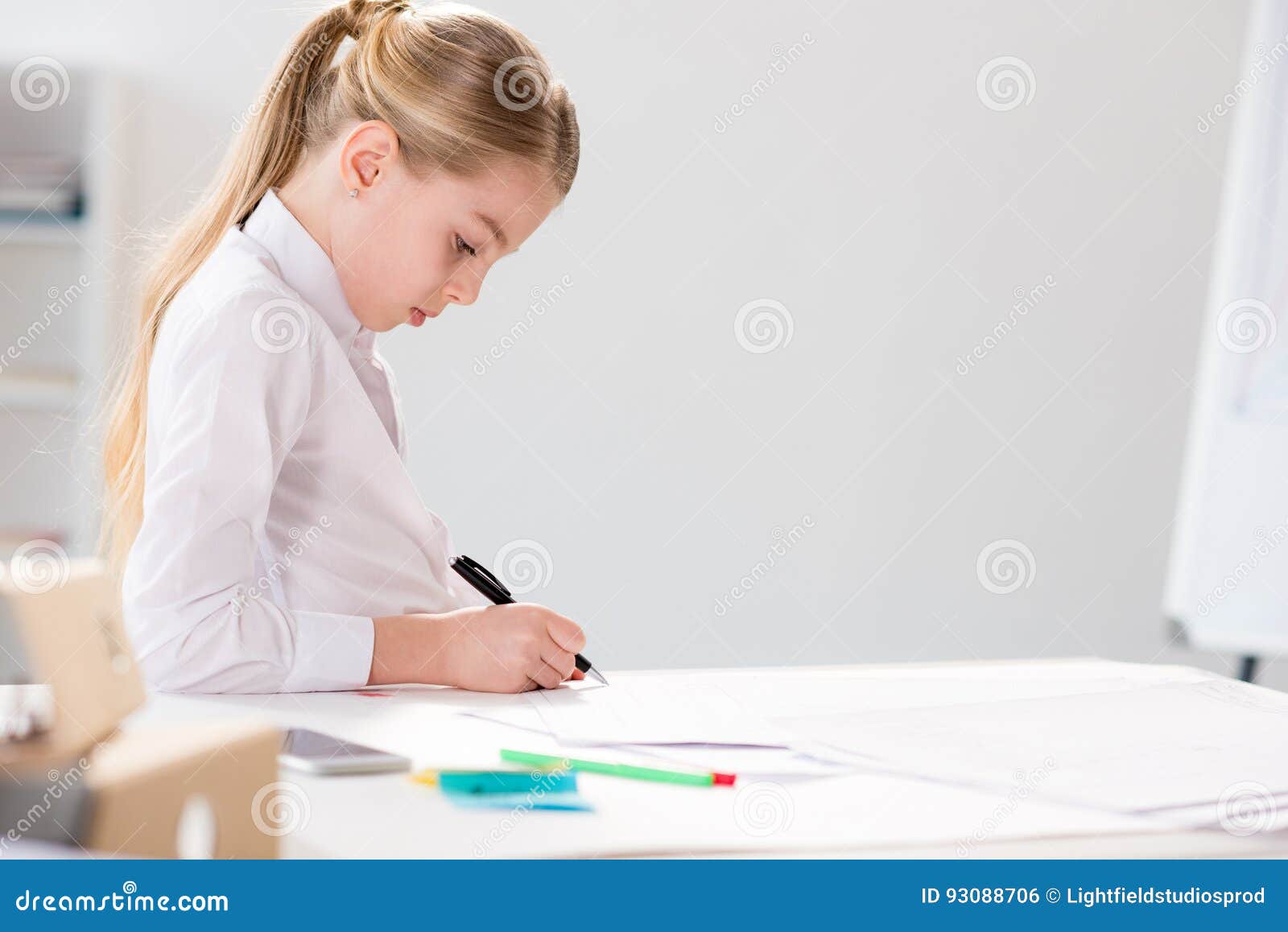 Serious Little Girl Writing at Table Stock Photo - Image of aspirations ...