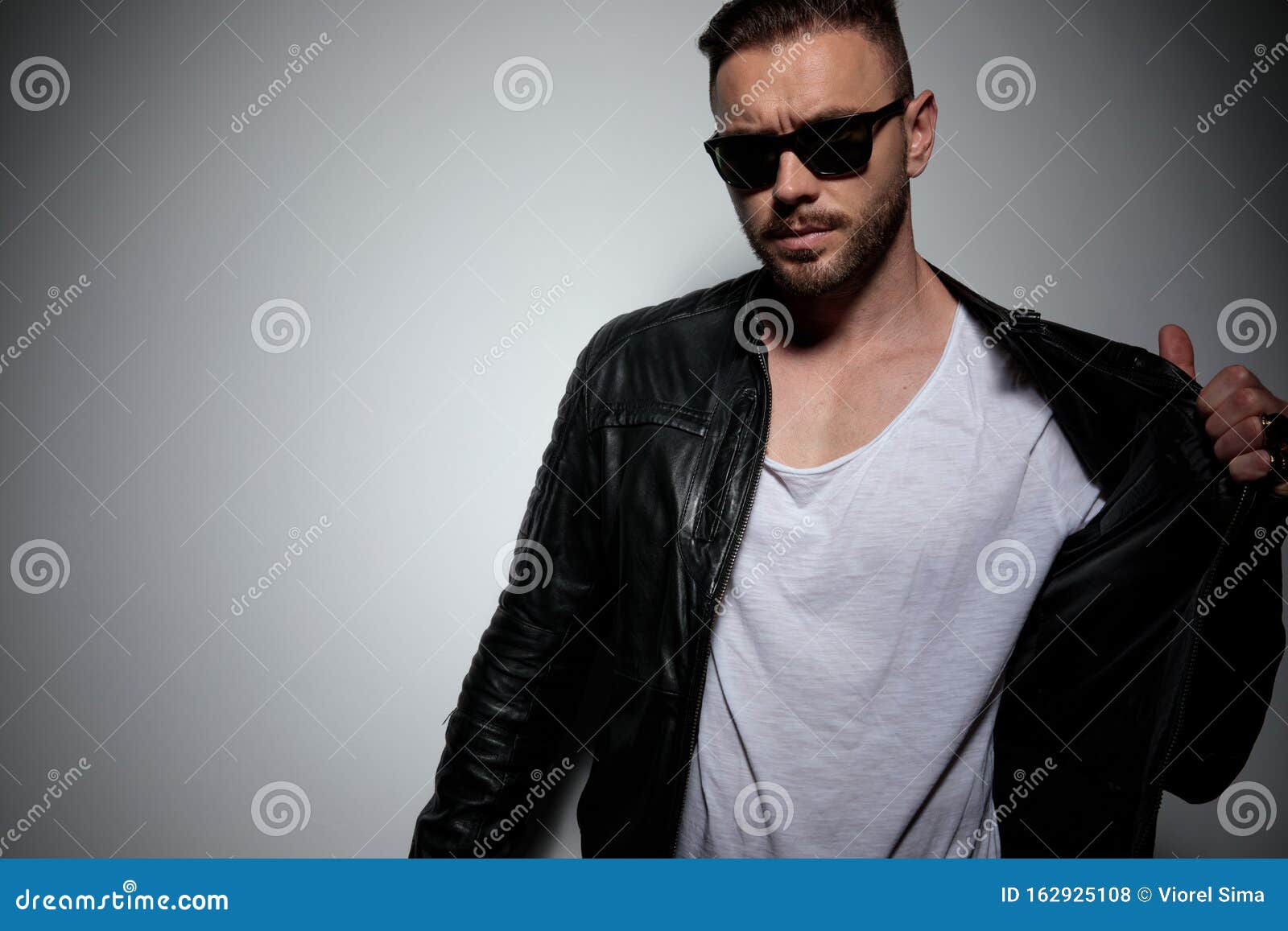 Serious Looking Dramatic Man Fixing and Pulling His Jacket Stock Photo ...