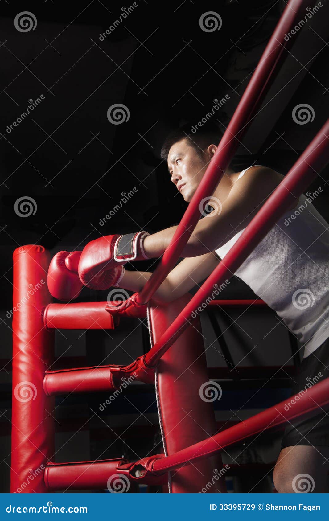 Serious Male Boxer Resting His Elbows on the Ring Side, Low Angle View ...