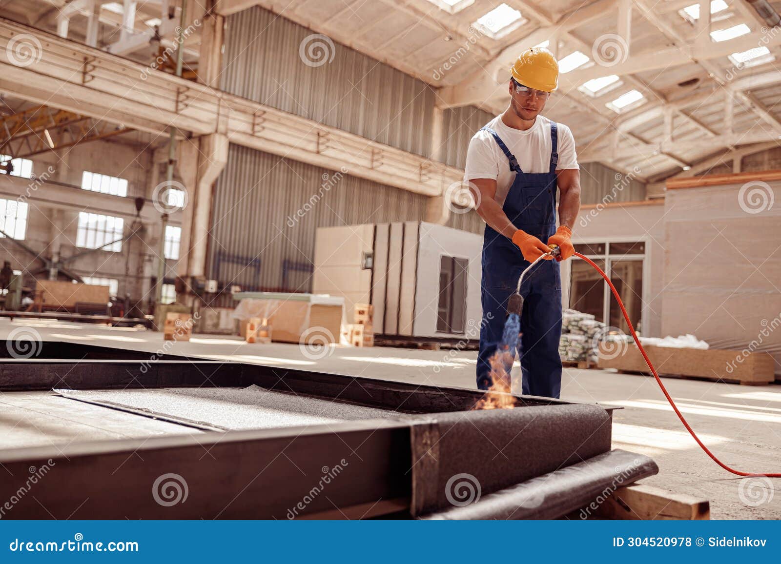 Serious Male Builder Using Gas Burner at Construction Site Stock Photo ...