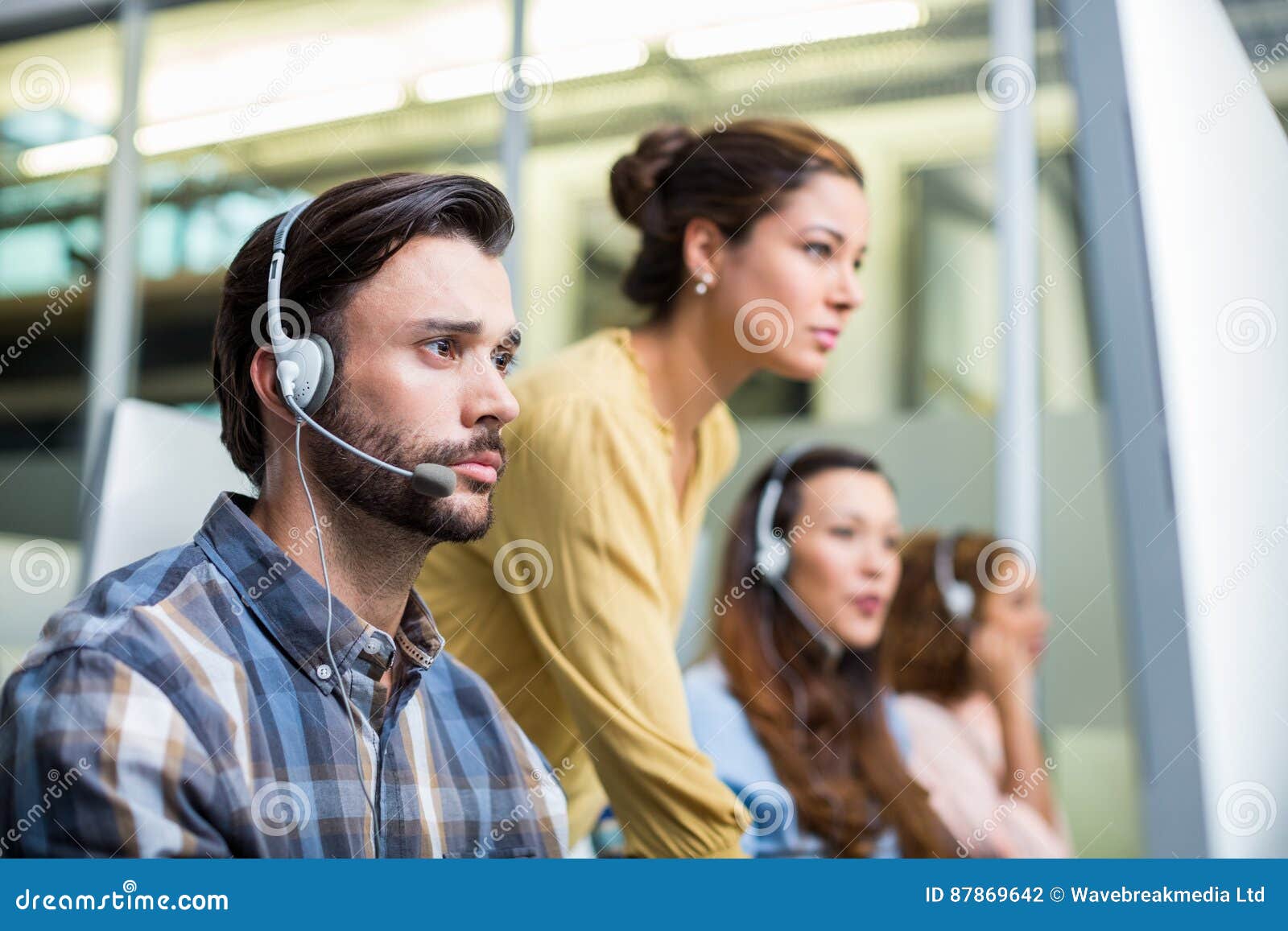 Serious Male Customer Service Executive Working at Desk Stock Photo ...