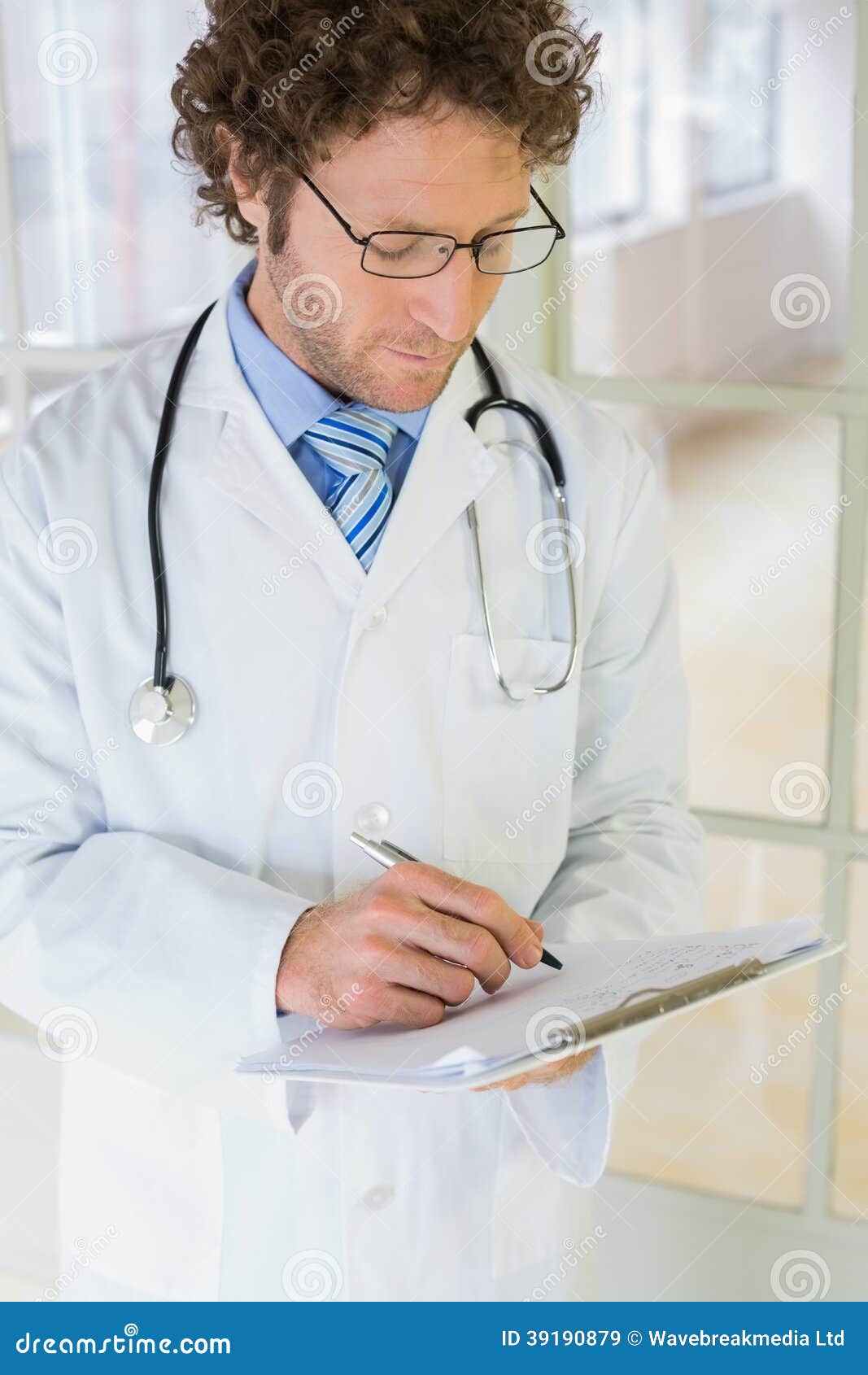 Serious Male Doctor Writing Reports in Hospital Stock Image - Image of ...