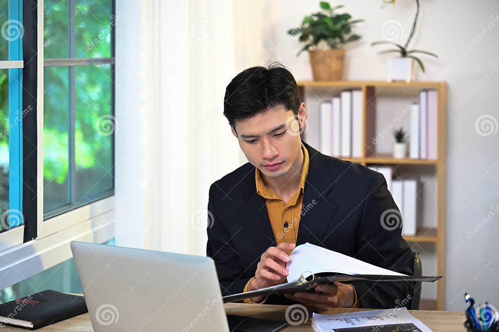 Serious Male Entrepreneur Checking Reports and Preparing a Presentation at Workspace Stock Image ...