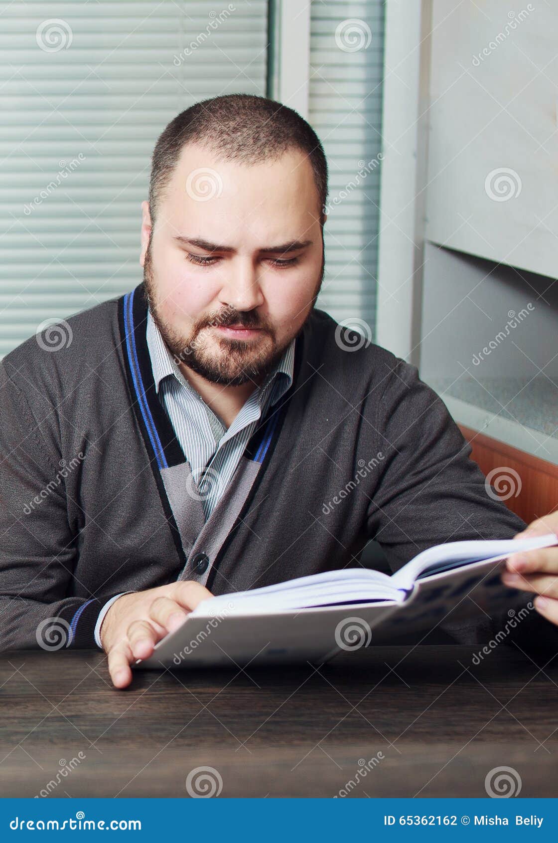 Serious Male Student Reading a Book Library Stock Photo - Image of ...