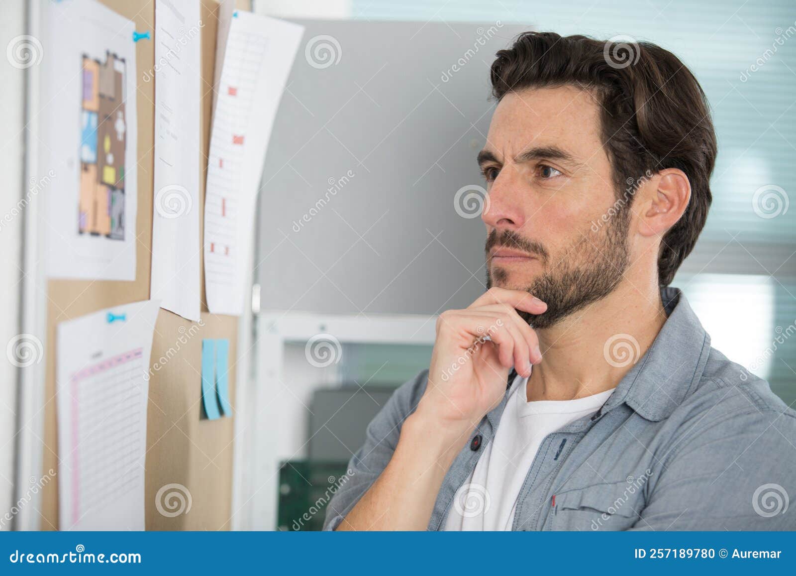 Serious Man Contemplates Information on Notice Board Stock Photo ...
