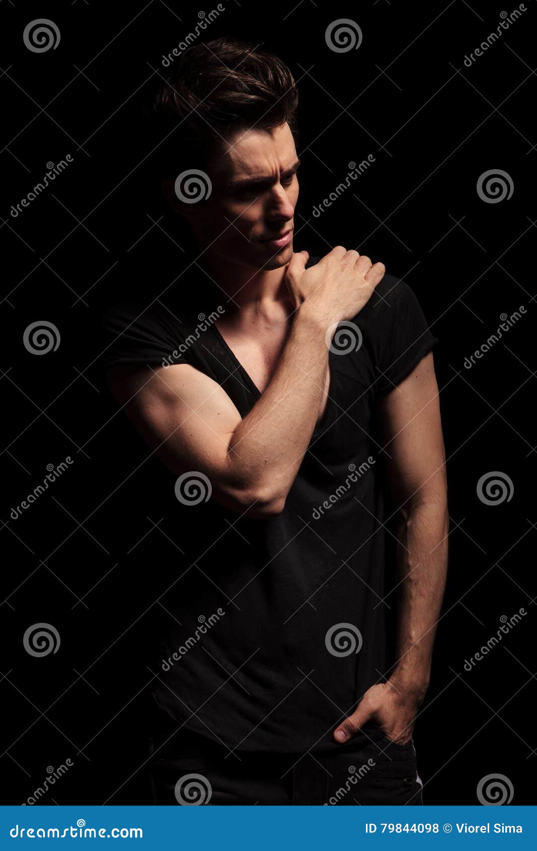 Serious Man Holding Hand on Shoulder and Looks Away Stock Photo - Image ...