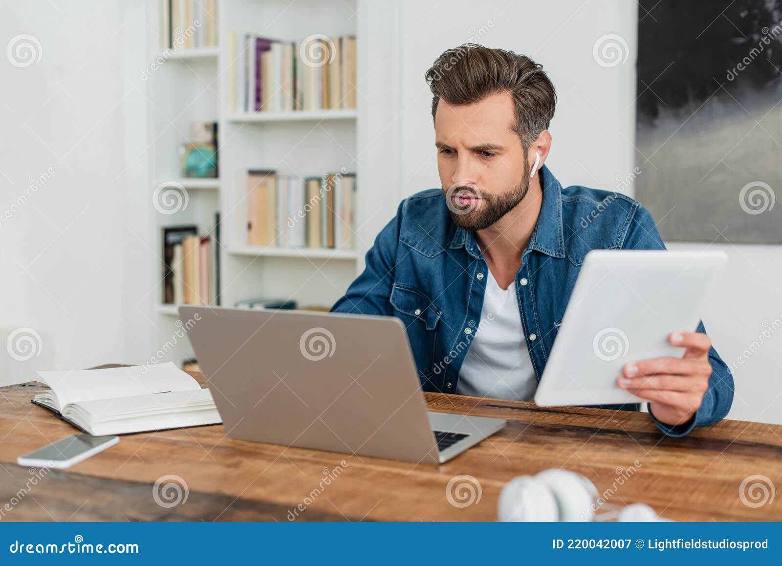 Serious Man Looking at Laptop while Stock Image - Image of mobile ...