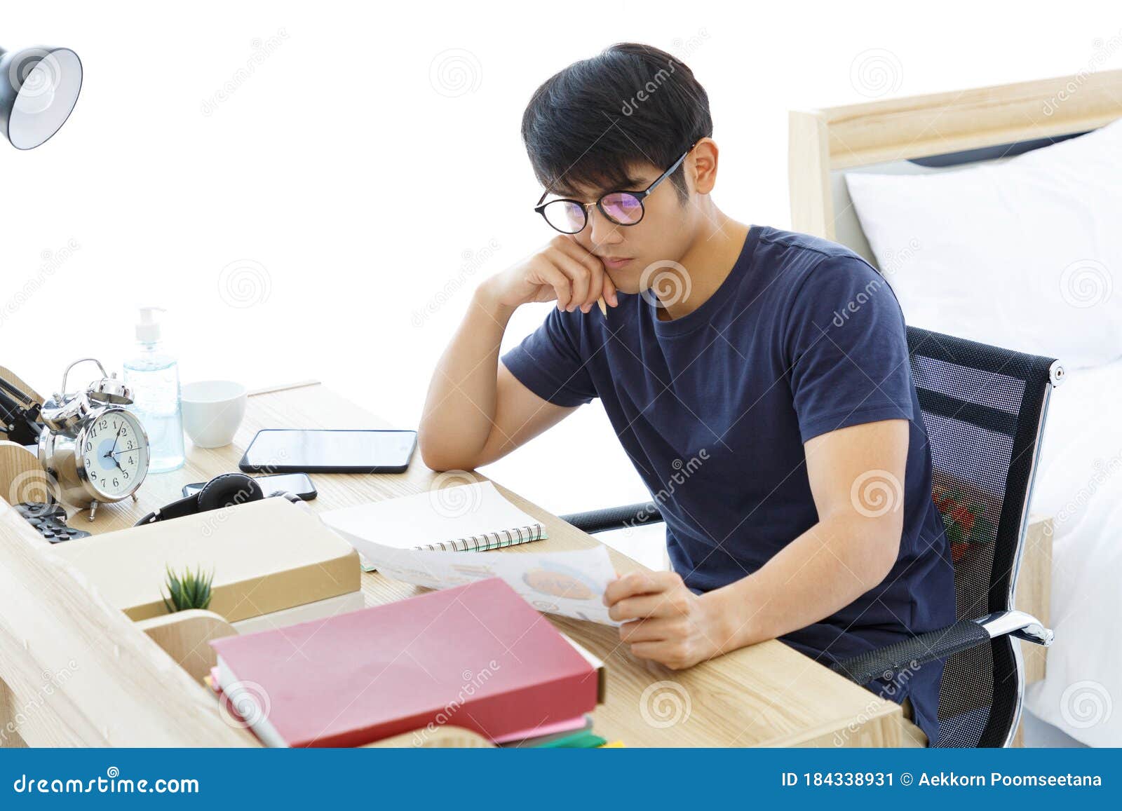 Serious Man Making Note and Checking on Paper Chart Report while ...