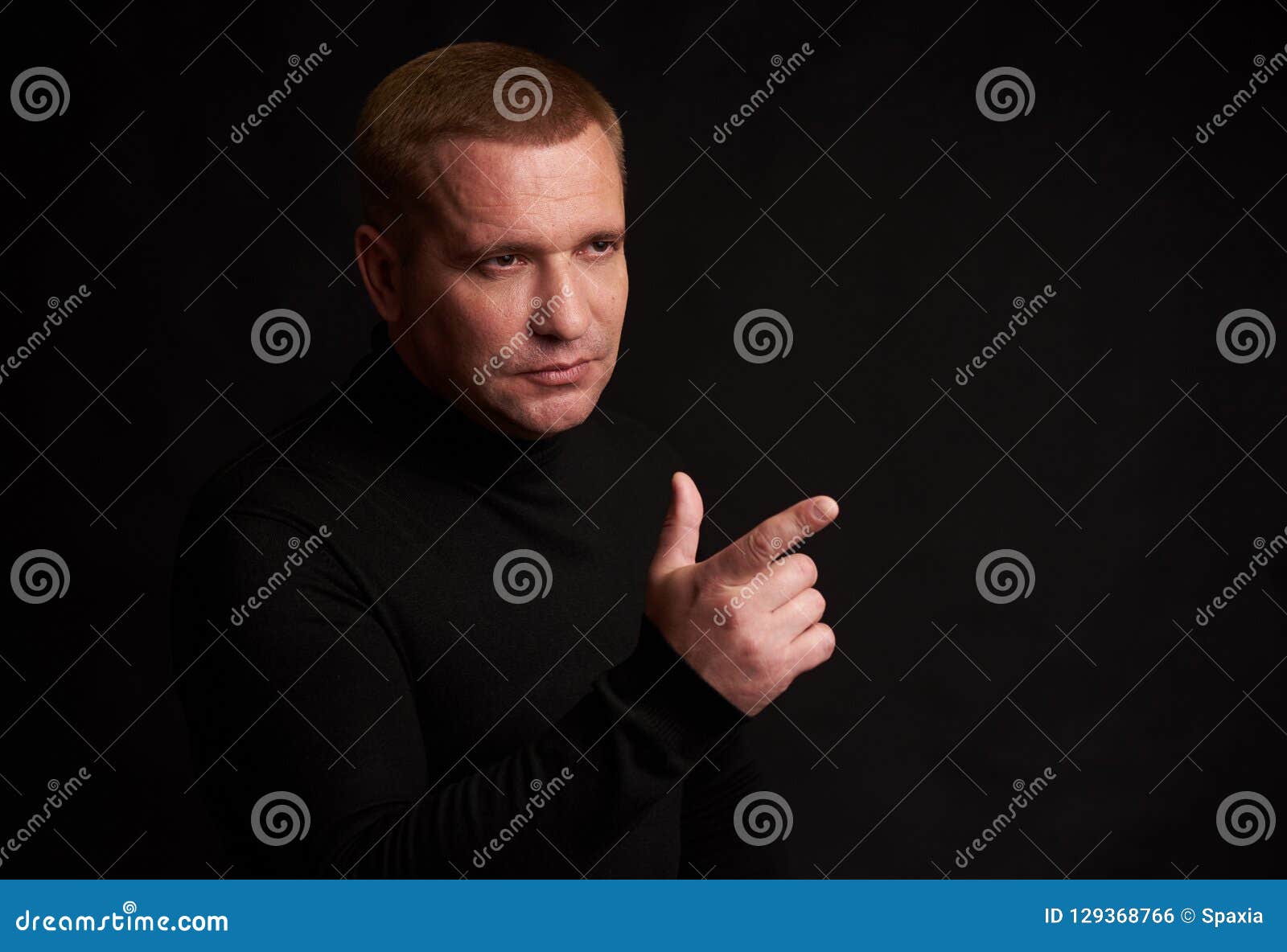 Serious Man Pointing Finger Over Black Background Stock Photo - Image ...
