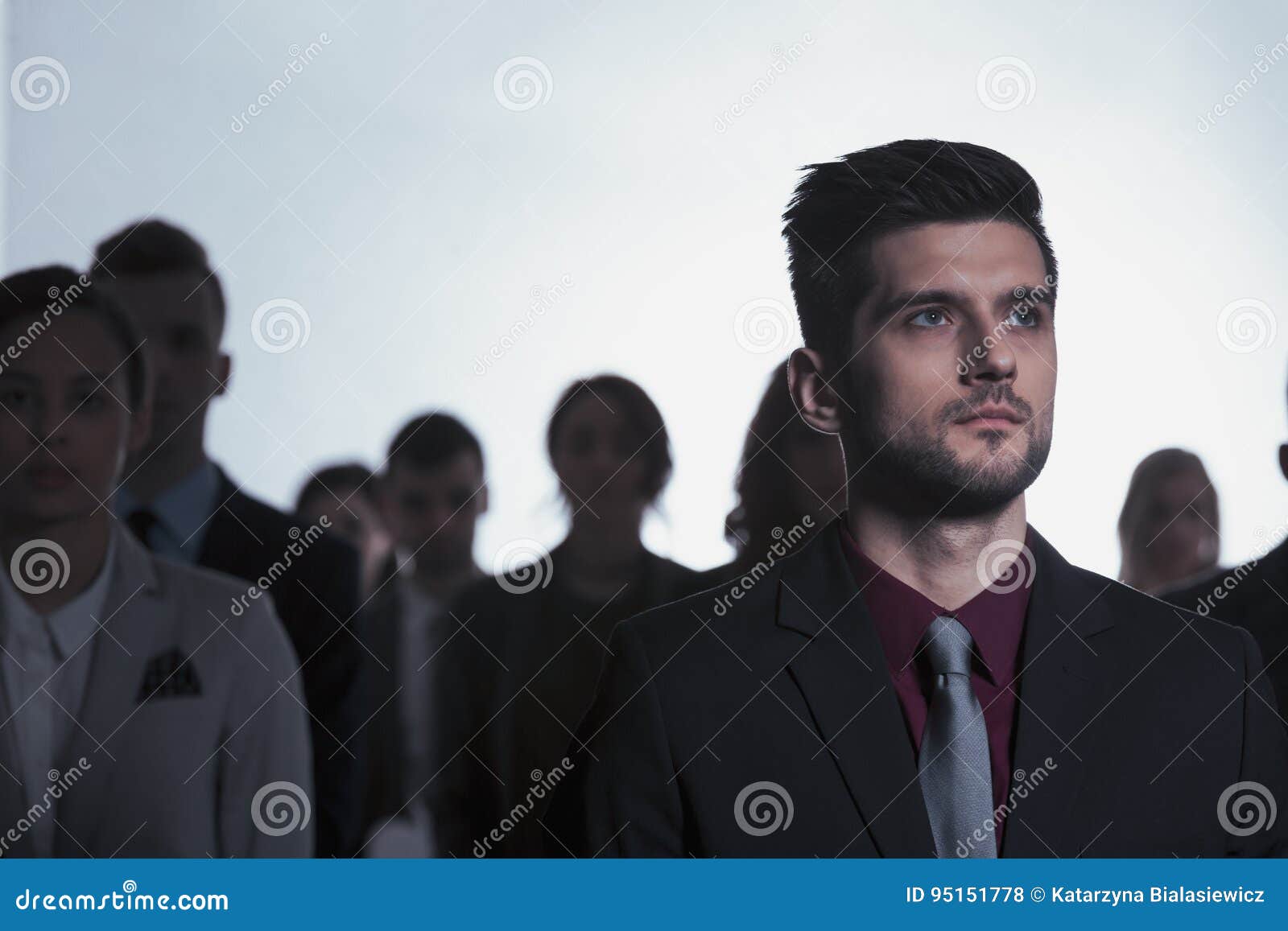 Serious Man Standing in Crowd Stock Photo - Image of illuminated, human ...
