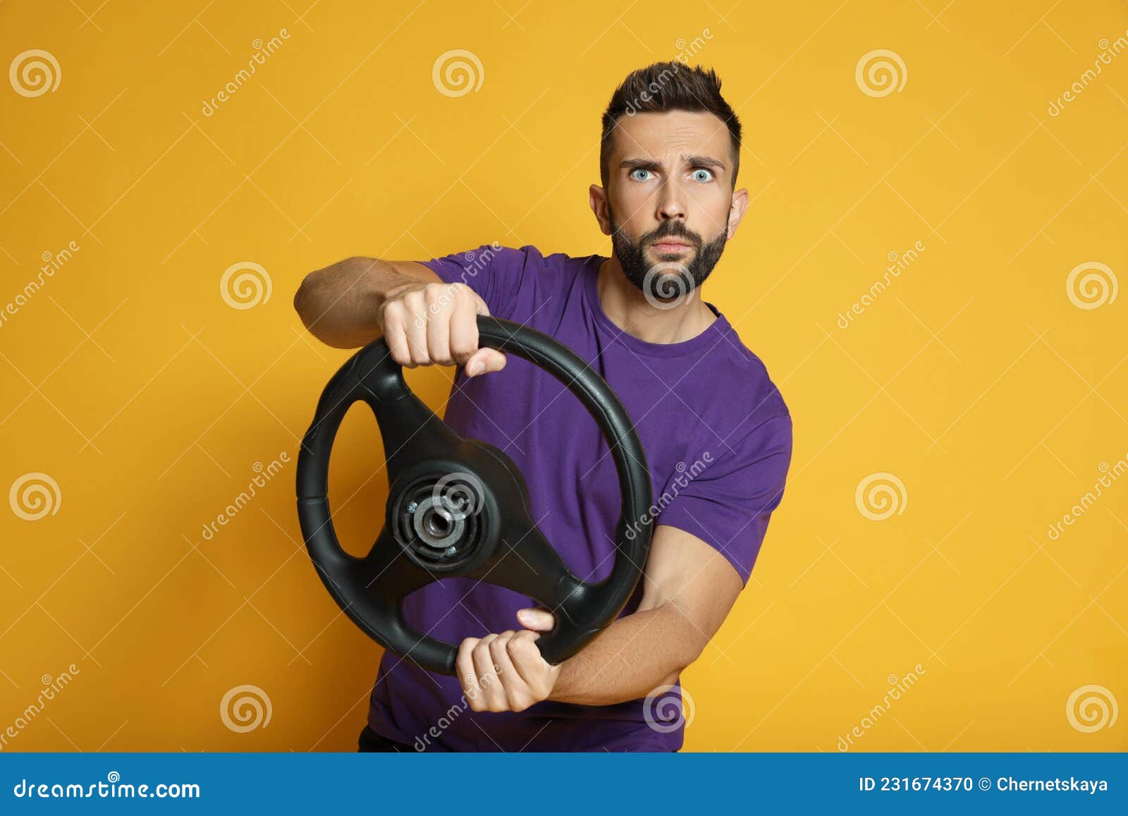 Serious Man with Steering Wheel on Yellow Background Stock Photo ...