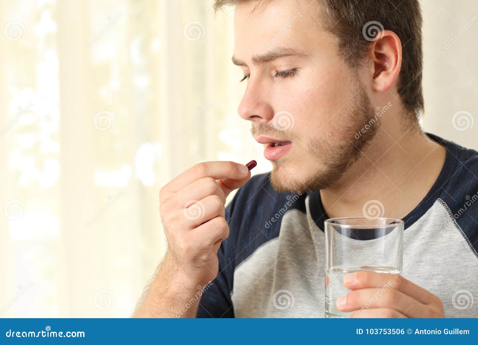 Serious Man Taking a Pill at Home Stock Photo - Image of allergic ...