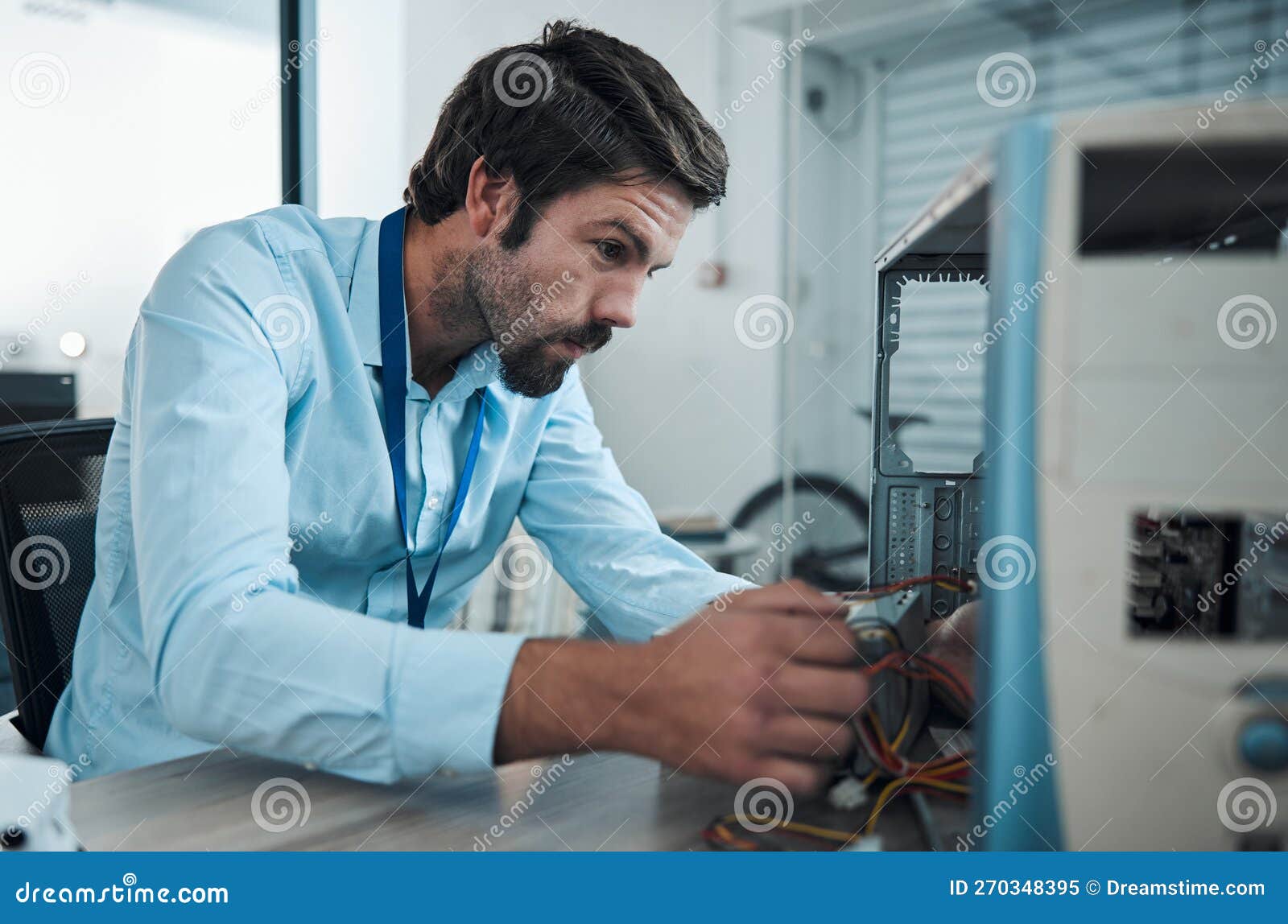Serious Man, it or Technician Fixing Computer, PC or Processor in ...