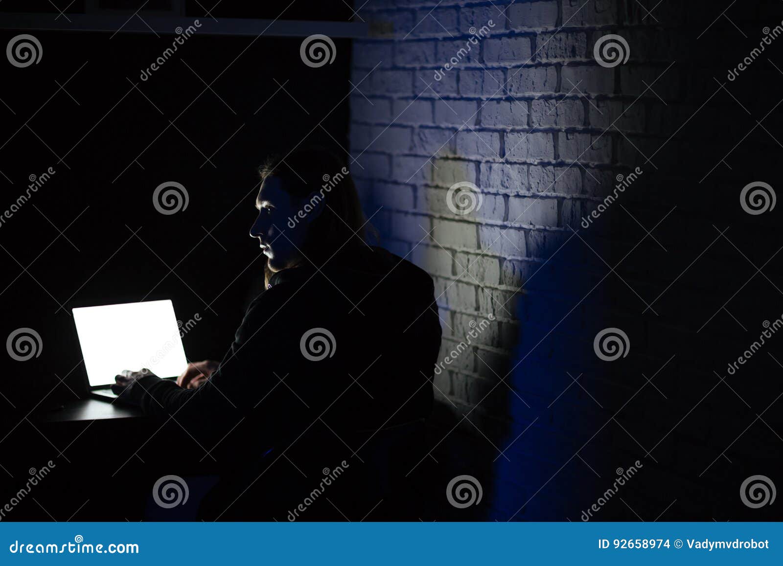 Serious Man Using Laptop Computer at Home Indoors at Night. Stock Photo ...