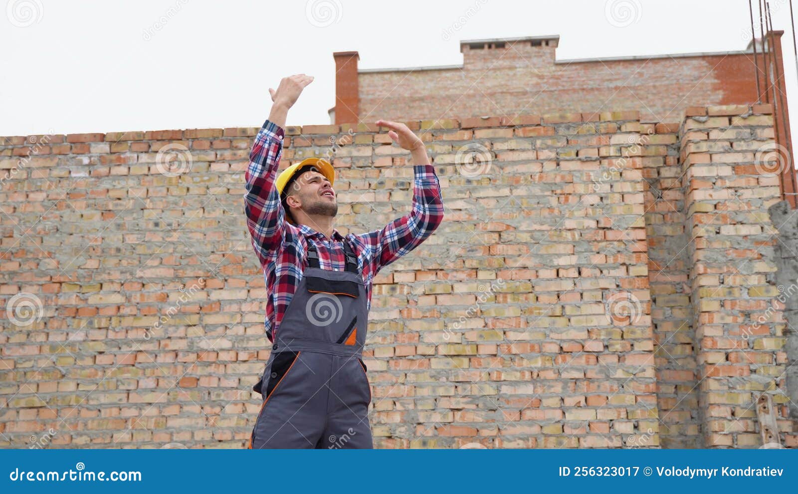 Serious Manager in Helmet and Uniform Giving Commands To Crane Operator ...