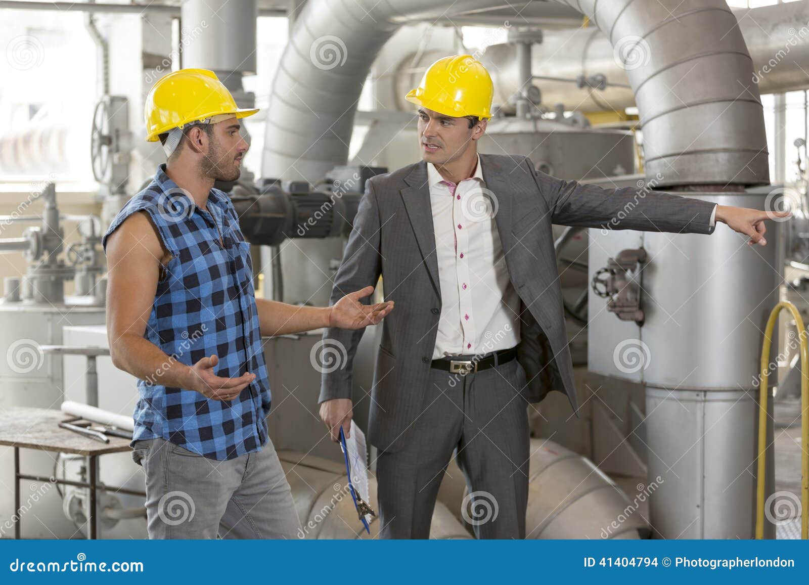 Serious Manager Showing Something To Worker in Industry Stock Photo ...