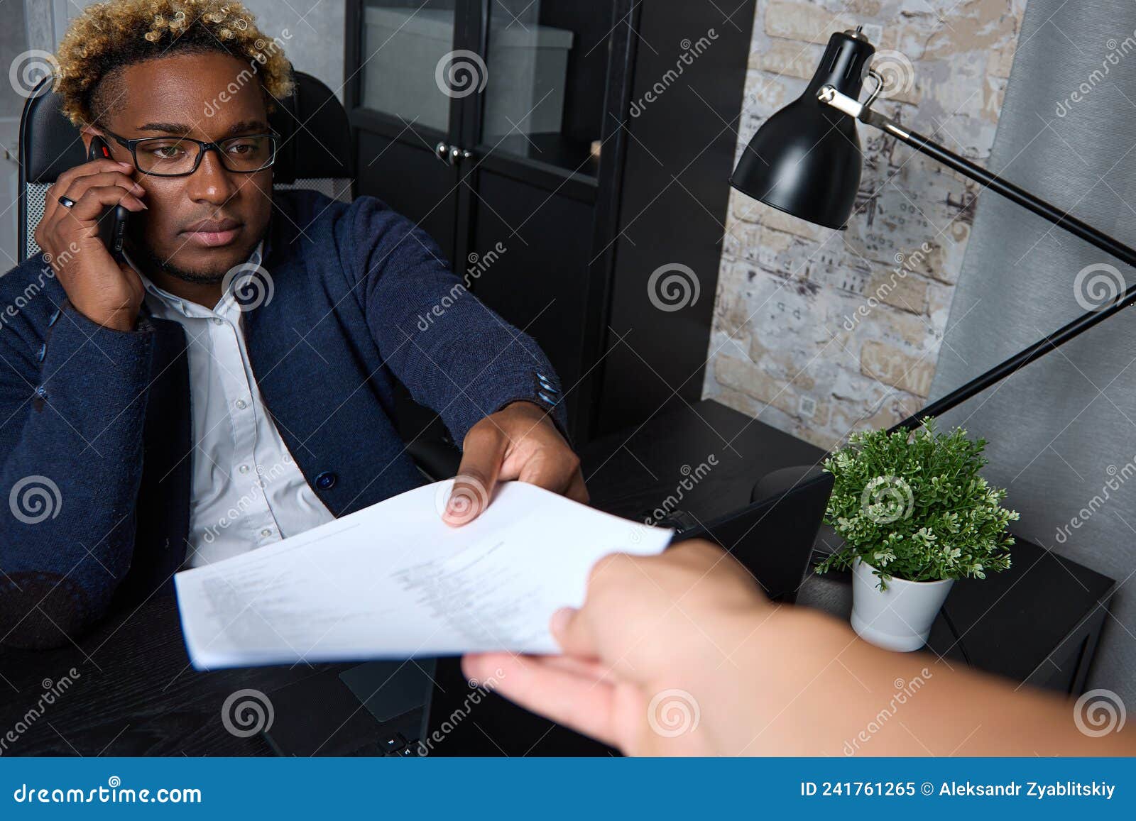 Manager Talks on Phone and Receives a Document for Signature from a ...