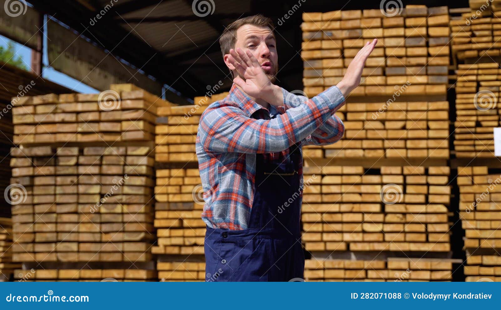 Serious Manager in Uniform Giving Commands To Workers on Lumber ...