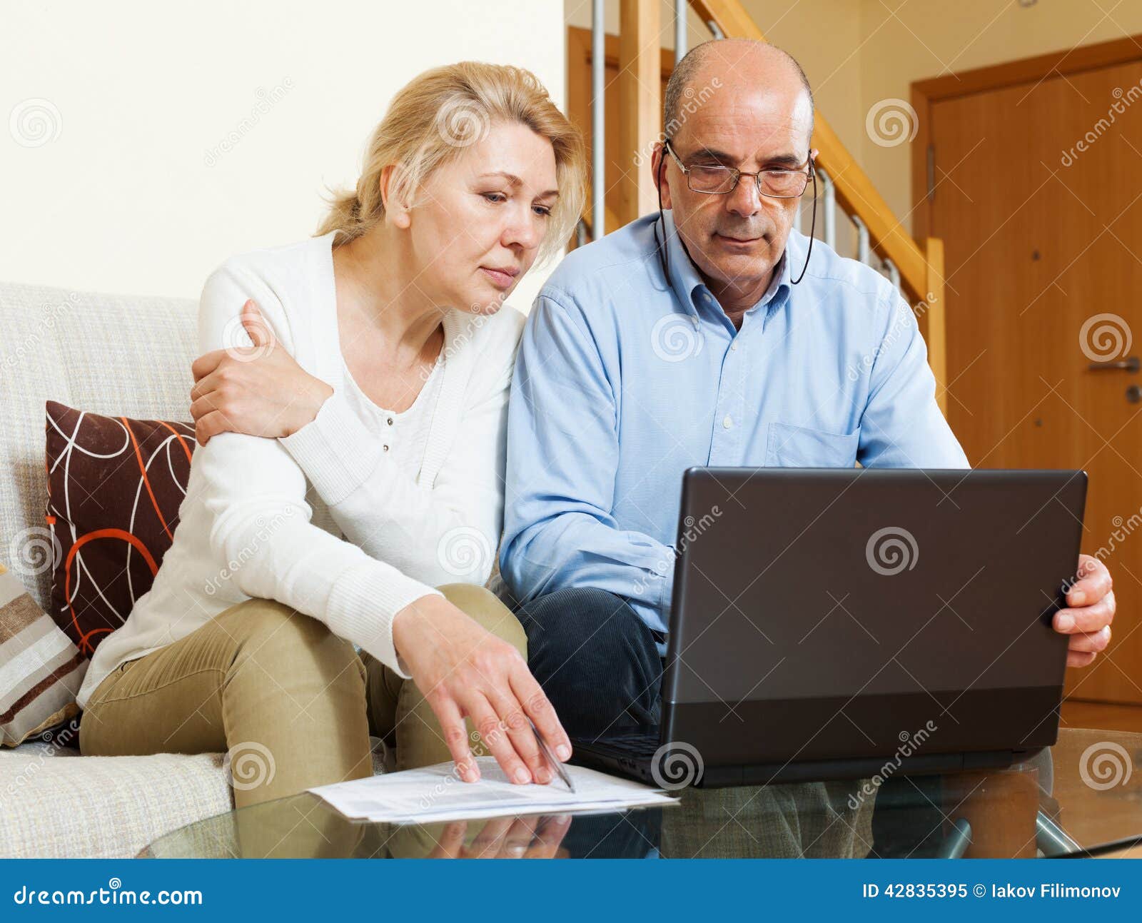 Serious Mature Couple Looking Documents in Laptop Stock Image - Image ...