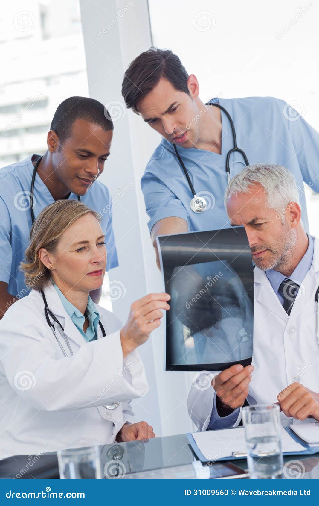 Serious Medical Team Examining Radiography Stock Photo - Image of ...