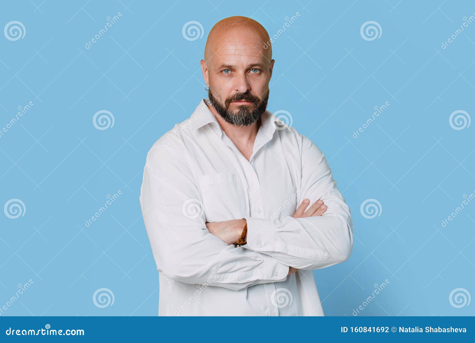 Serious Middle-aged Man with Folded Arms and a Deadpan Expression ...