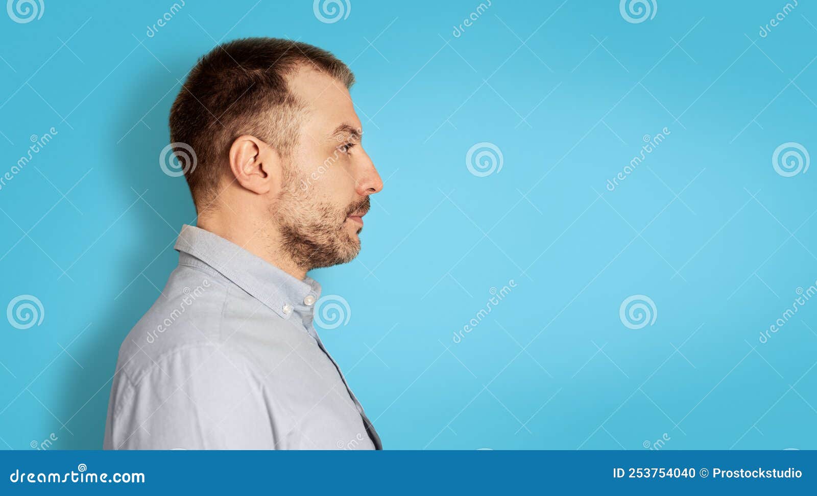 Serious Middle Aged Man Looking Aside, Blue Background, Side View Stock ...